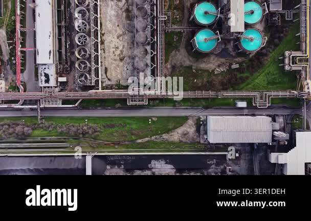 Aerial view of an industrial facility showing large storage tanks ...