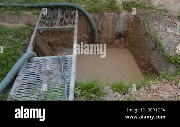 Workers are drilling a well to access clean water. The process involves ...