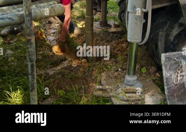 Workers are drilling a water well in a rural area. The process involves ...