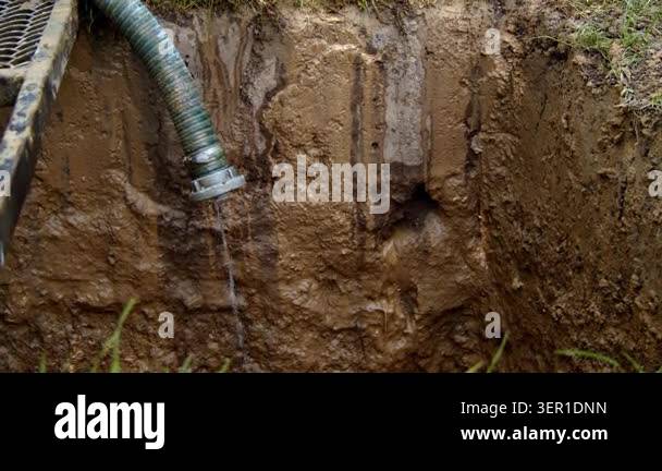 Workers are drilling into the earth to extract water for a well. Water ...