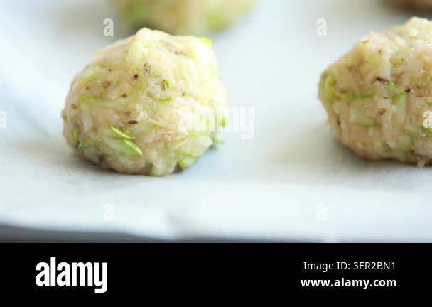 Close-up of raw, unbaked zucchini tots arranged in neat rows on a ...