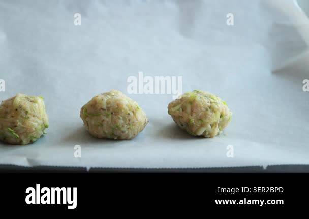 Close-up of raw, unbaked zucchini tots arranged in neat rows on a ...