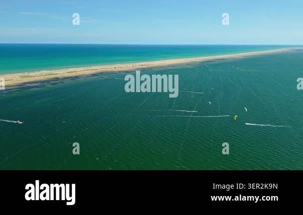 Aerial view of kitesurfers and colorful kites near Punta del Fangar ...