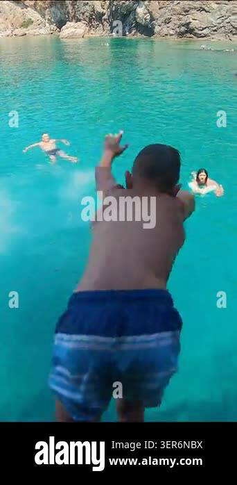 Sports boy 8-9 year old jumps somersault, from wooden sailing ship into ...