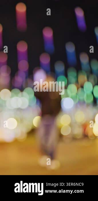 Slow motion of crowds of people walking and blurred lights shot with ...