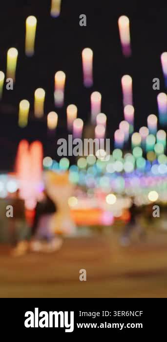 Slow motion of crowds of people walking and blurred lights shot with ...