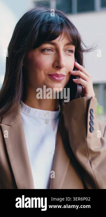 Smiling self employed woman making phone call on mobile phone and ...