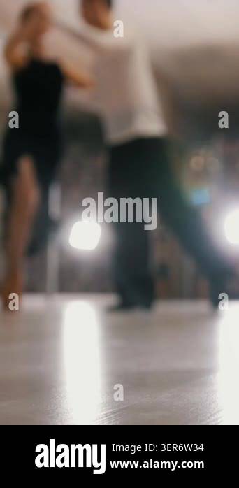 Blurred professional man and woman dancing Latin dance in costumes in ...