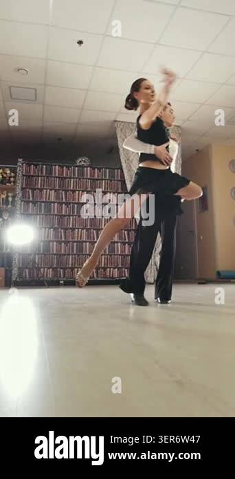 Young attractive man and woman dancing and practicing Latin American ...