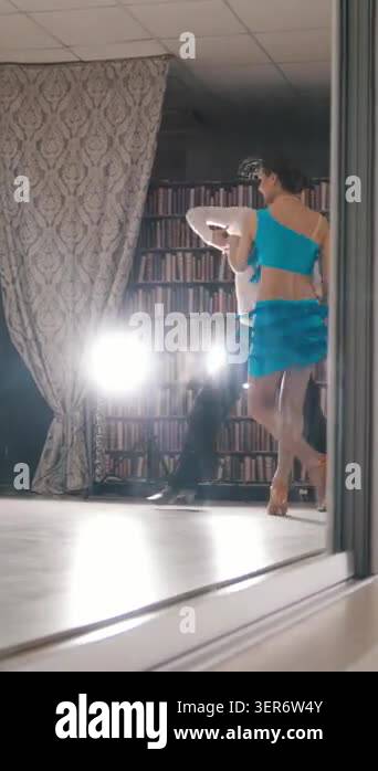 Young attractive man and woman dancing Latin dance in costumes in the ...