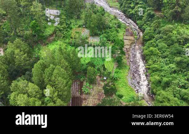 River winds through lush green valley. Farmland nestled beside the ...