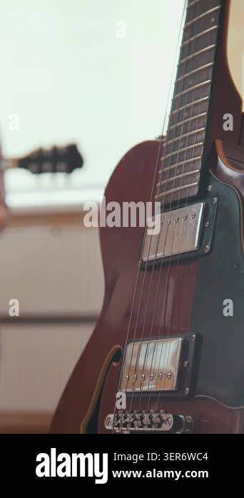 Young attractive man composes music on the guitar and play, other ...