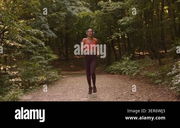 Woman jogging on woodland trail feeling sharp pain in the side of her ...