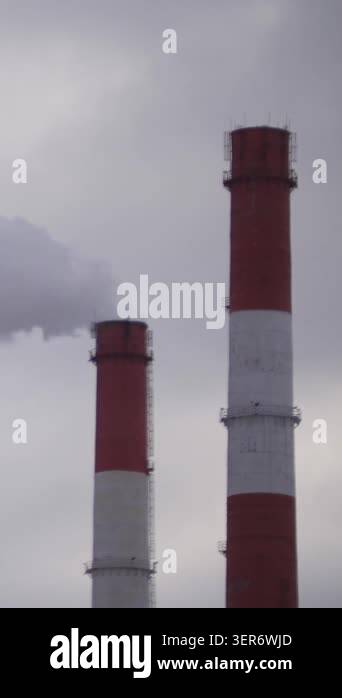 The pipe with smoke in cloudy sky - chemical industry, telephoto shot ...