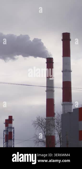 Industrial pipes pollute in the Atmosphere With Smoke, telephoto shot ...