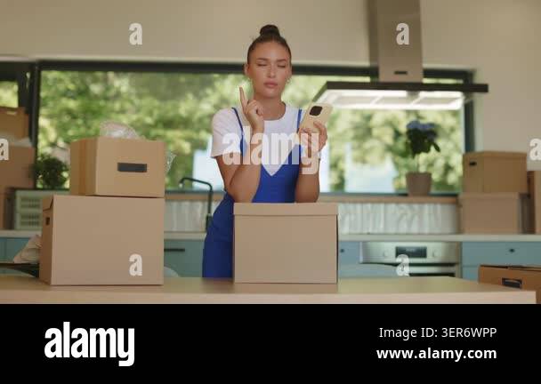 Thoughtful young woman writing checklist in smartphone while standing ...