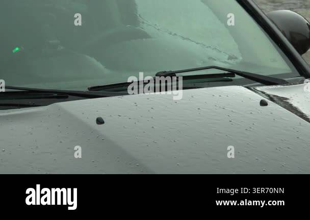 Car windshield rain covered during heavy downpour. Raindrops on front ...