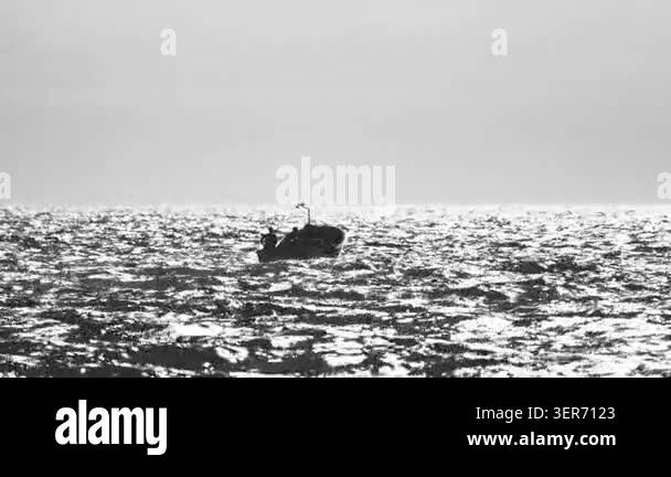 A whale breaches the surface of the ocean with force. Water splashes ...