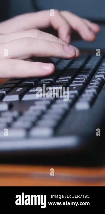 Man in black shirt typing on computer keyboard near personal computer ...