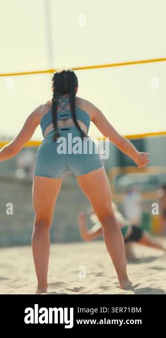 A player stands ready to serve during a beach volleyball match in ...