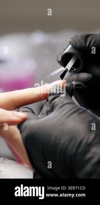 Manicure in beauty shop - cosmetic master in medical mask deals polish ...
