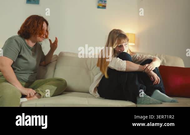 Caucasian mother scolding her sad teenage daughter during a difficult ...
