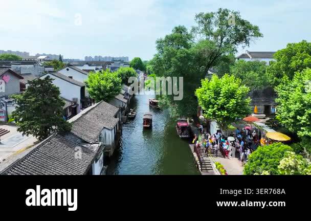 Aerial view of Chinese Jiangnan ancient water town canal with boats ...