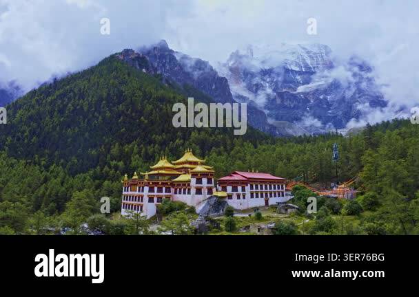 Aerial view of classical Tibetan temple on green mountain slope of ...