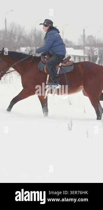 Woman rider on red horse riding on snow field, telephoto shot Stock ...