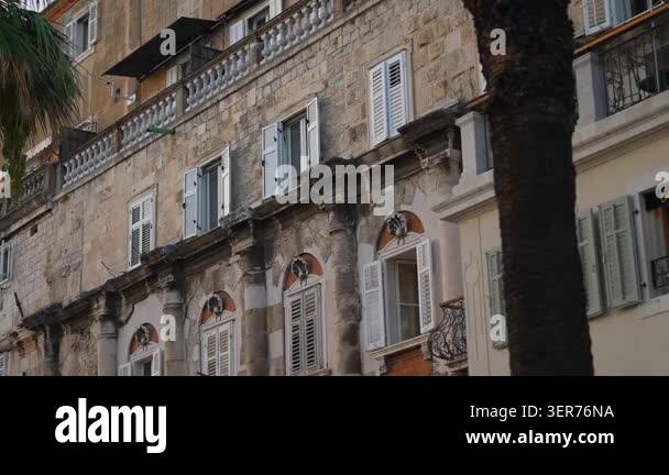 Historic stone building facade with shutters Stock Video Footage - Alamy