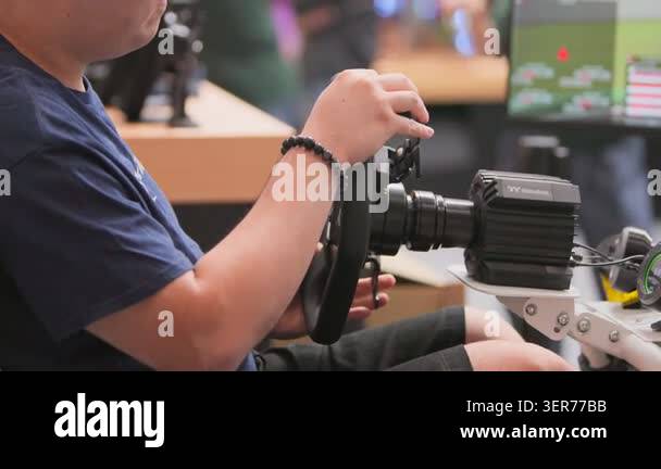 Taipei, Taiwan-23 May, 2025: Visitors test a driving simulator with ...