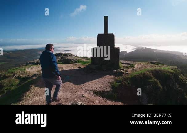 Explorer reaching a mountaintop, contemplating a magnificent expanse of ...