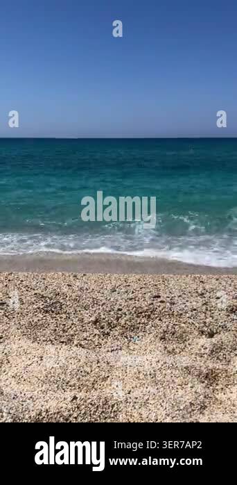 Beautiful scenic view of clear turquoise ocean waves gently crashing on ...