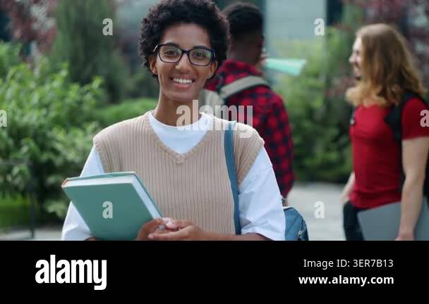 Happy African American student girl showing thumb up smiling at camera ...