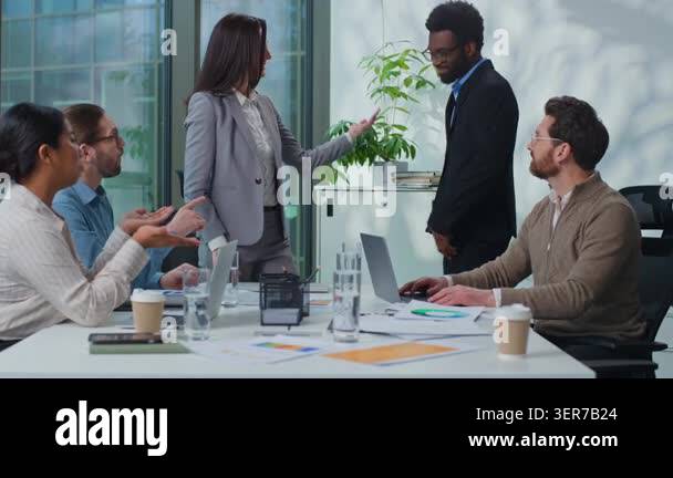 Caucasian woman boss with multiethnic business team applauding greeting ...