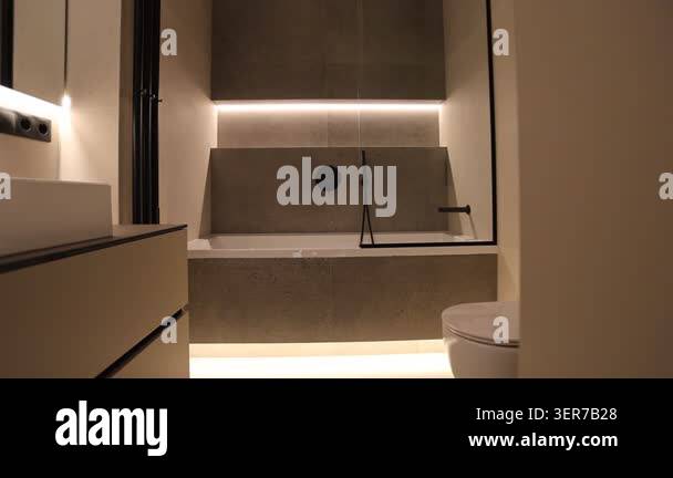 Centered view of a clean minimalist bathroom featuring a wall mounted ...