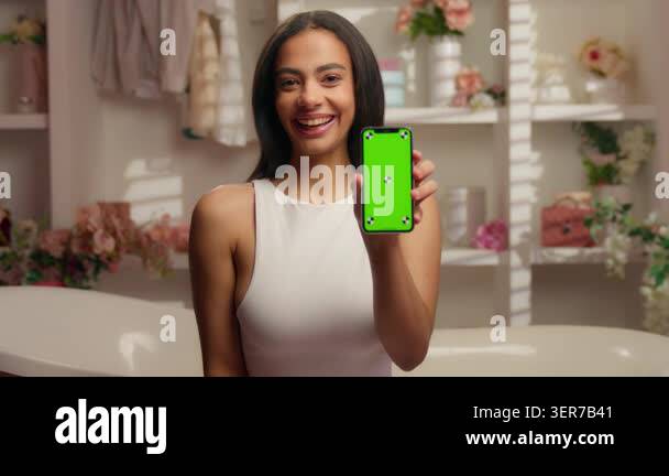 Portrait Hispanic woman showing green screen thumb up recommend online ...