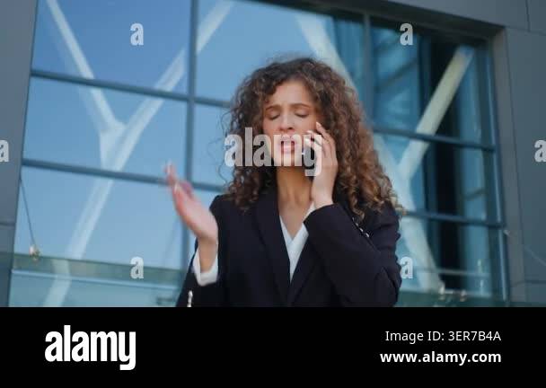 Angry Caucasian business woman boss screaming talking mobile phone tell ...
