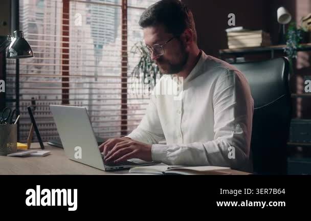 Happy Caucasian businessman typing laptop indoor office man showing ...
