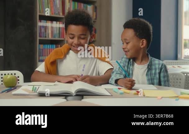 Two little boys African American children writing exercise study in ...