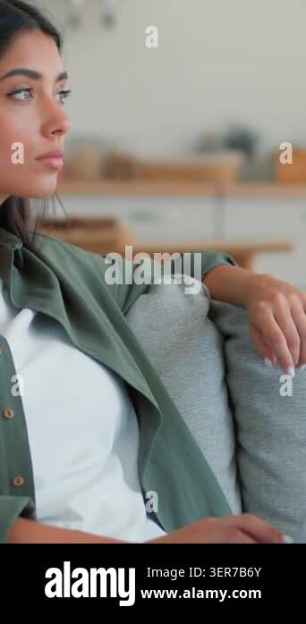 Pensive Indian woman using laptop computer thinking typing freelancer ...