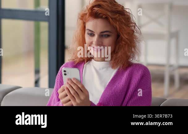 Happy smiling carefree Caucasian woman lady girl indoors at home couch ...