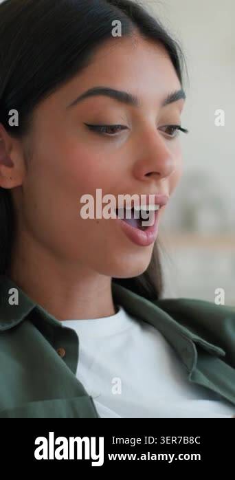 Happy surprised Indian woman using smartphone at home browsing social ...