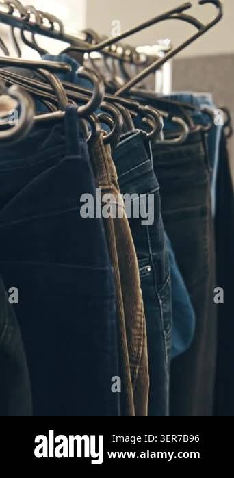 Rows Of Used Denim Jeans Hanging In A Second-Hand Shop, Vertical Video ...