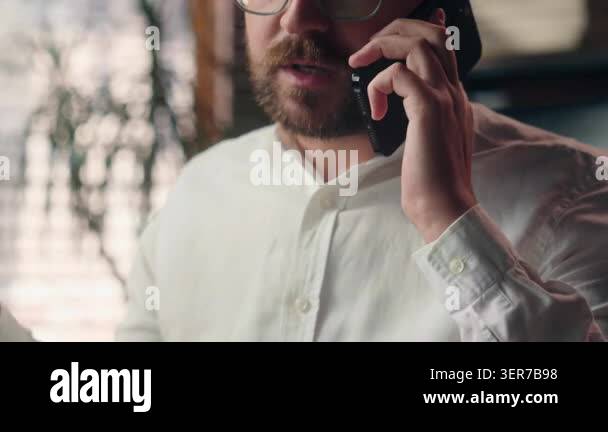 Stressed Caucasian business man talking on mobile phone in office ...