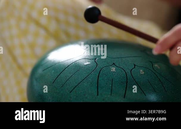 Close-Up View Of Female Hands Playing A Steel Tongue Drum With Rubber ...