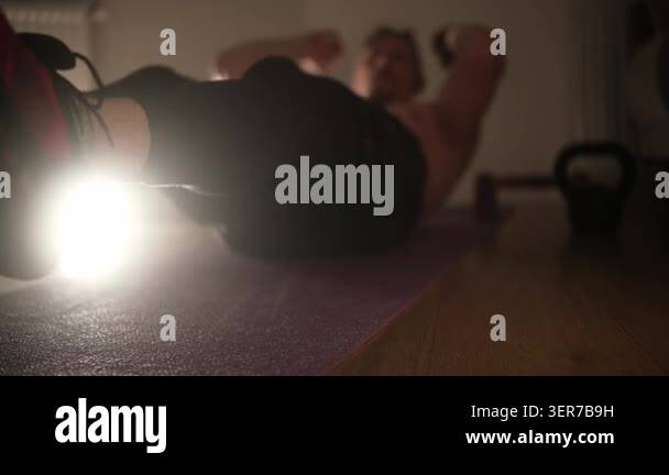 Athletic Man Exercises Core Abdominal Muscles On The Floor At Home In ...