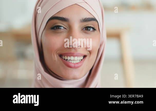 Happy smiling Arabian Muslim woman in hijab talking looking camera ...