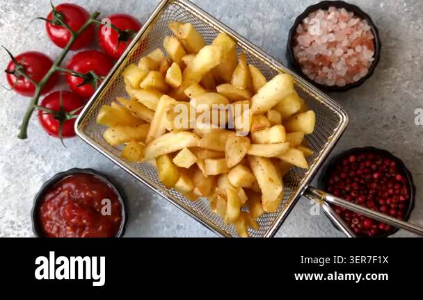 Golden French fries fried with salt and spices, unhealthy takeaway food ...