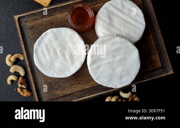 Brie or Camembert cheese is a white, round shape for baking and melting ...